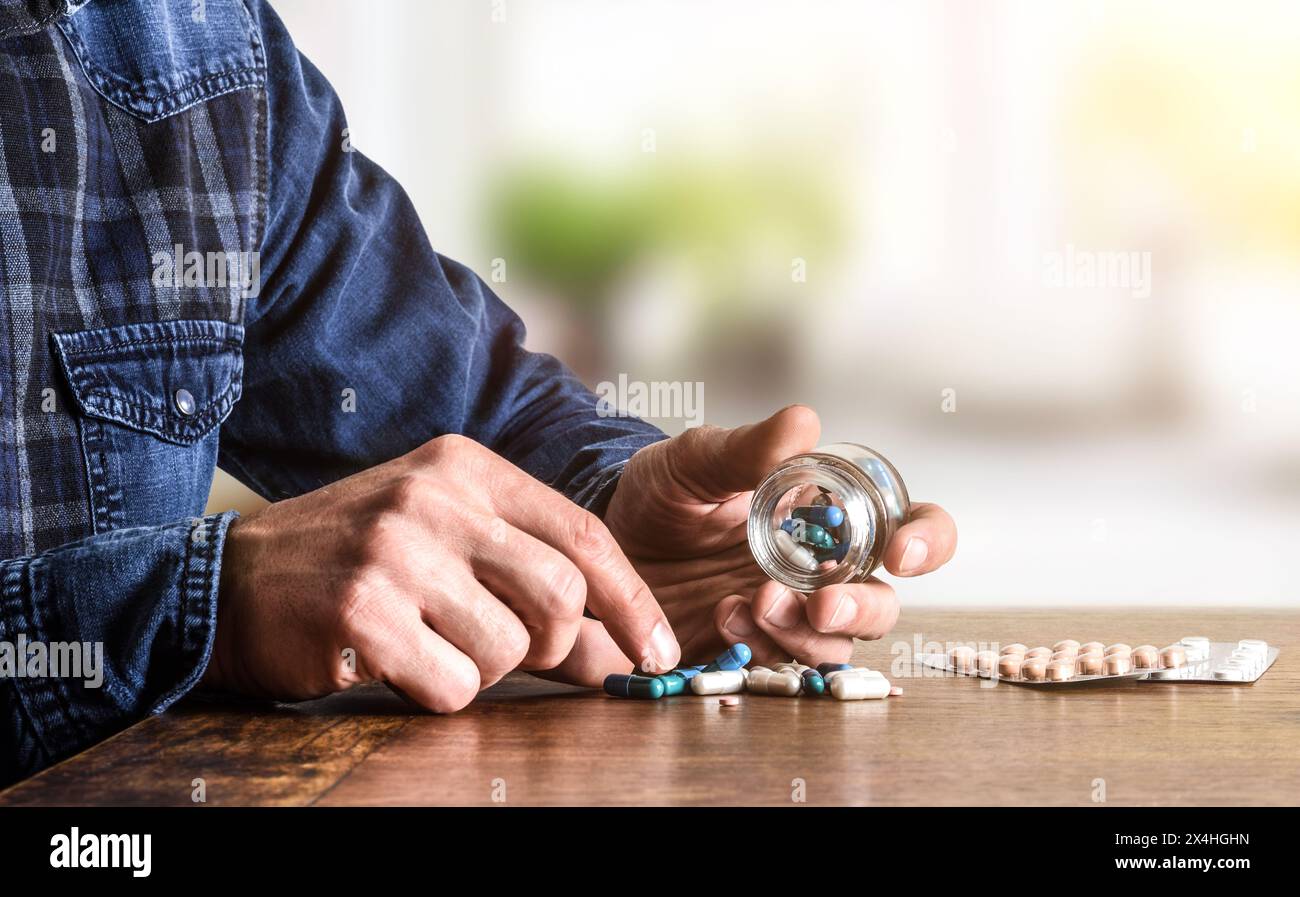 Detail of person taking a medical treatment pill to take with glass ...