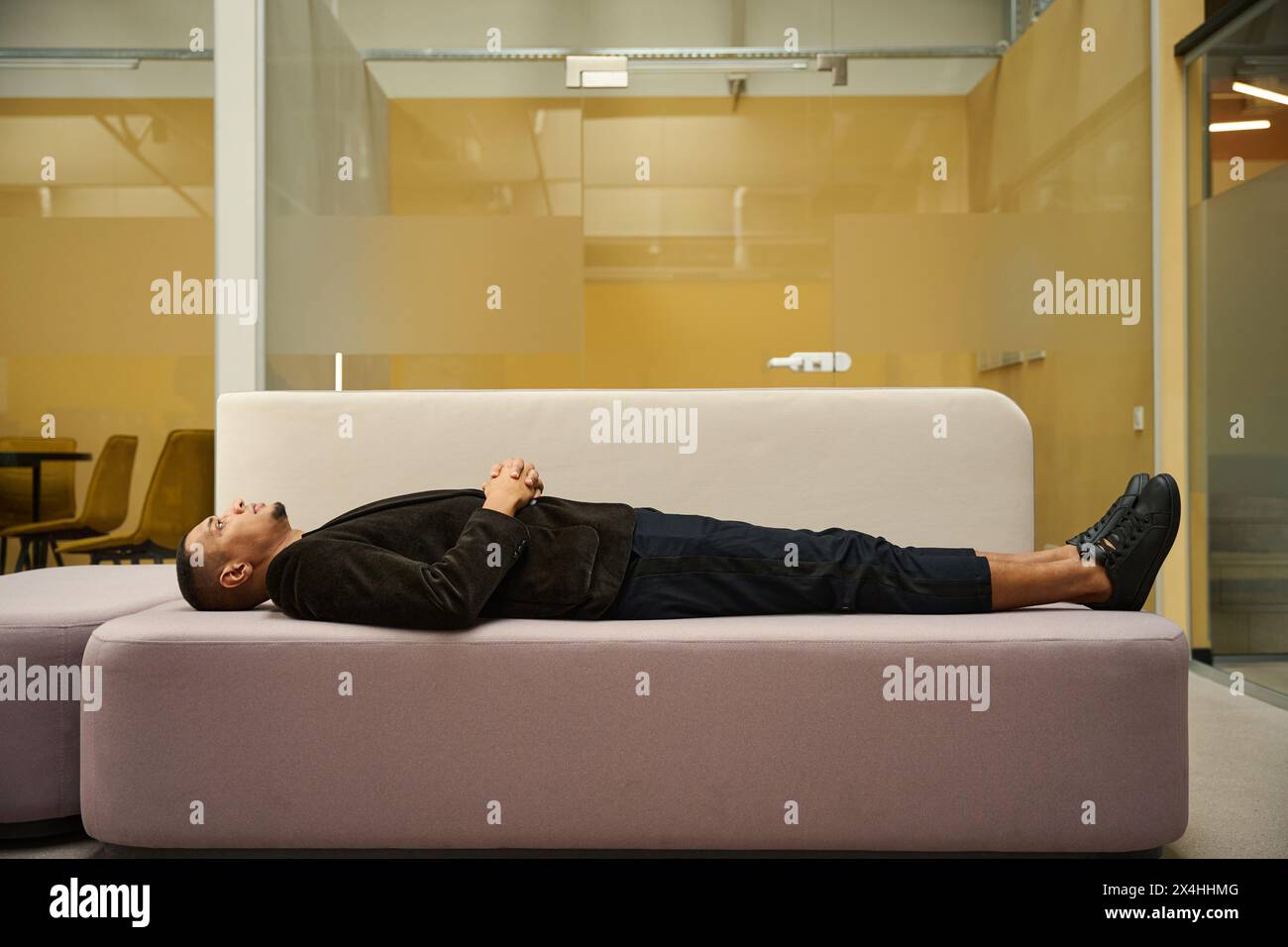 Serious young african man lying hi-res stock photography and images - Alamy