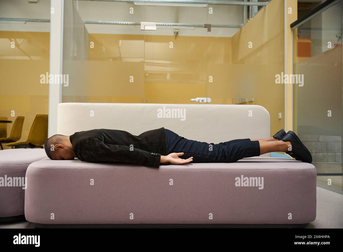 Tired male employee sleeping on sofa in office Stock Photo - Alamy
