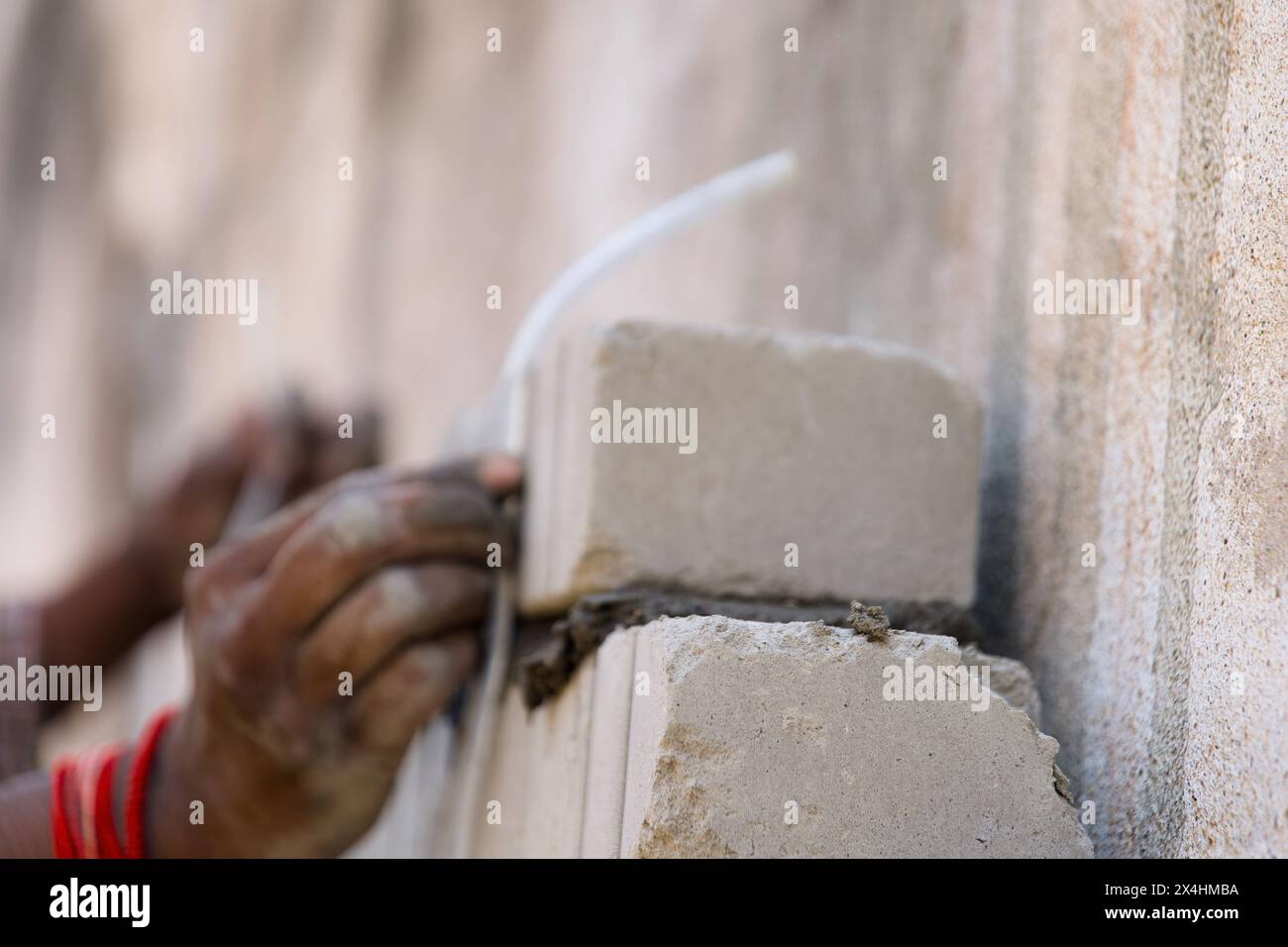 A close-up view of a construction worker carefully checking the ...