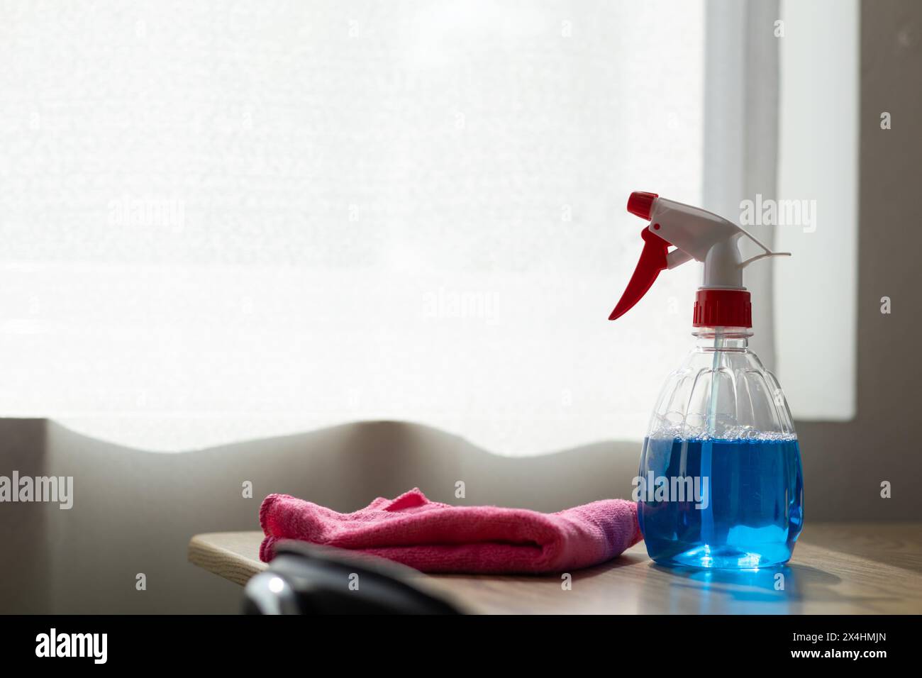 The disinfectant-based cleaning solution is prepared in a spray bottle ...