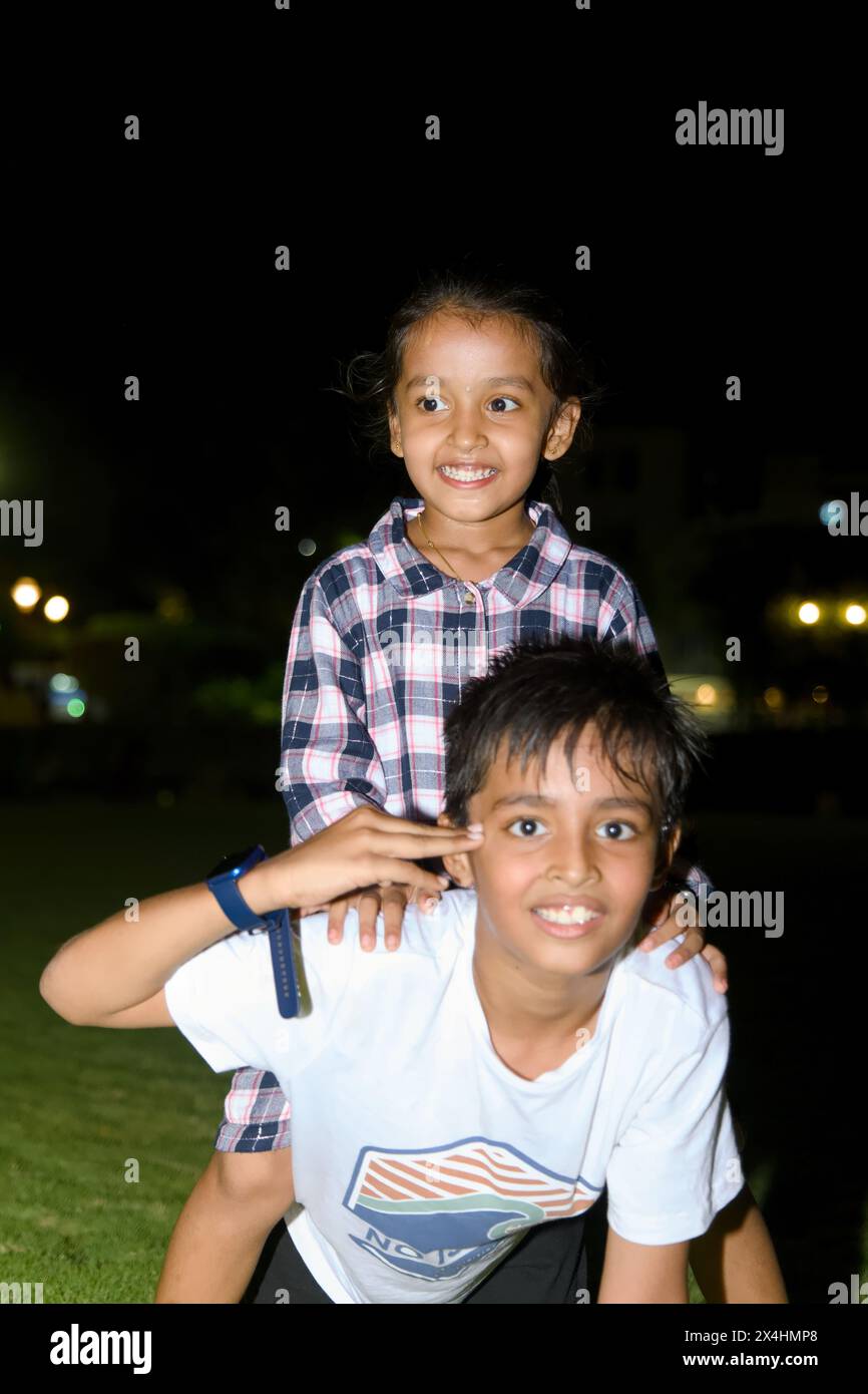 this image is about Portrait of a brother and sister playing in the ...