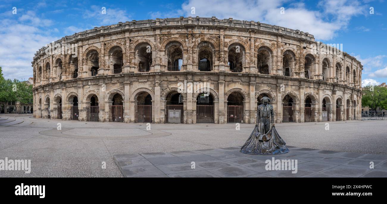 Nîmes, France - 04 17 2024: View of the Arena of Nimes and the bronze ...