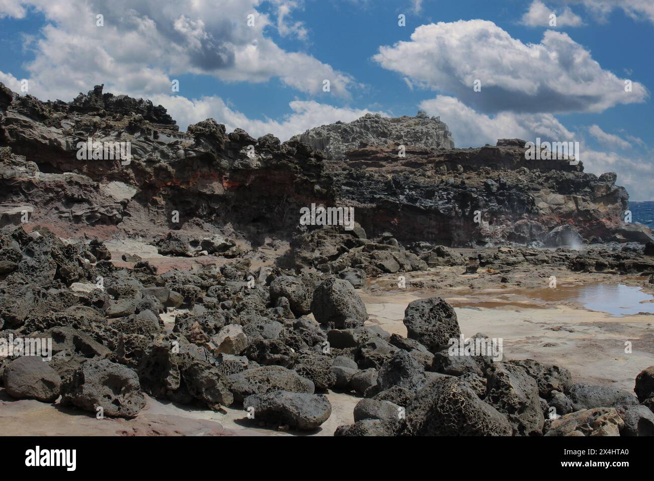 The Nakalele Blowhole, surrounded by a sunken crater of volcanic rock ...