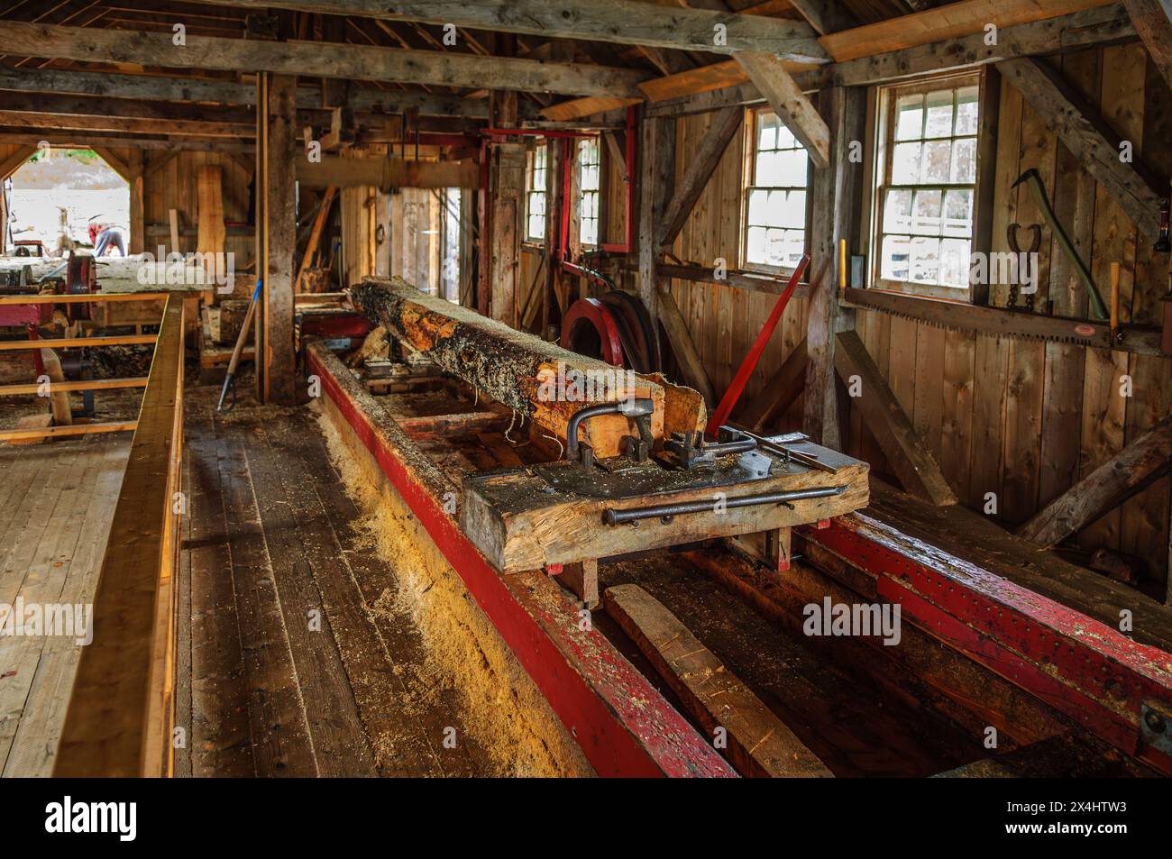 A log on a carriage being sawn by a head saw at a historic water ...