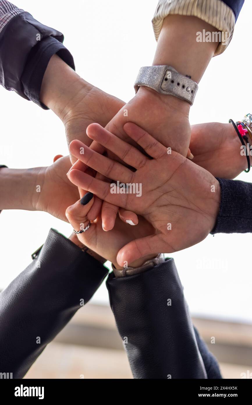 Low angle of group of people bumping fists. Togetherness and ...