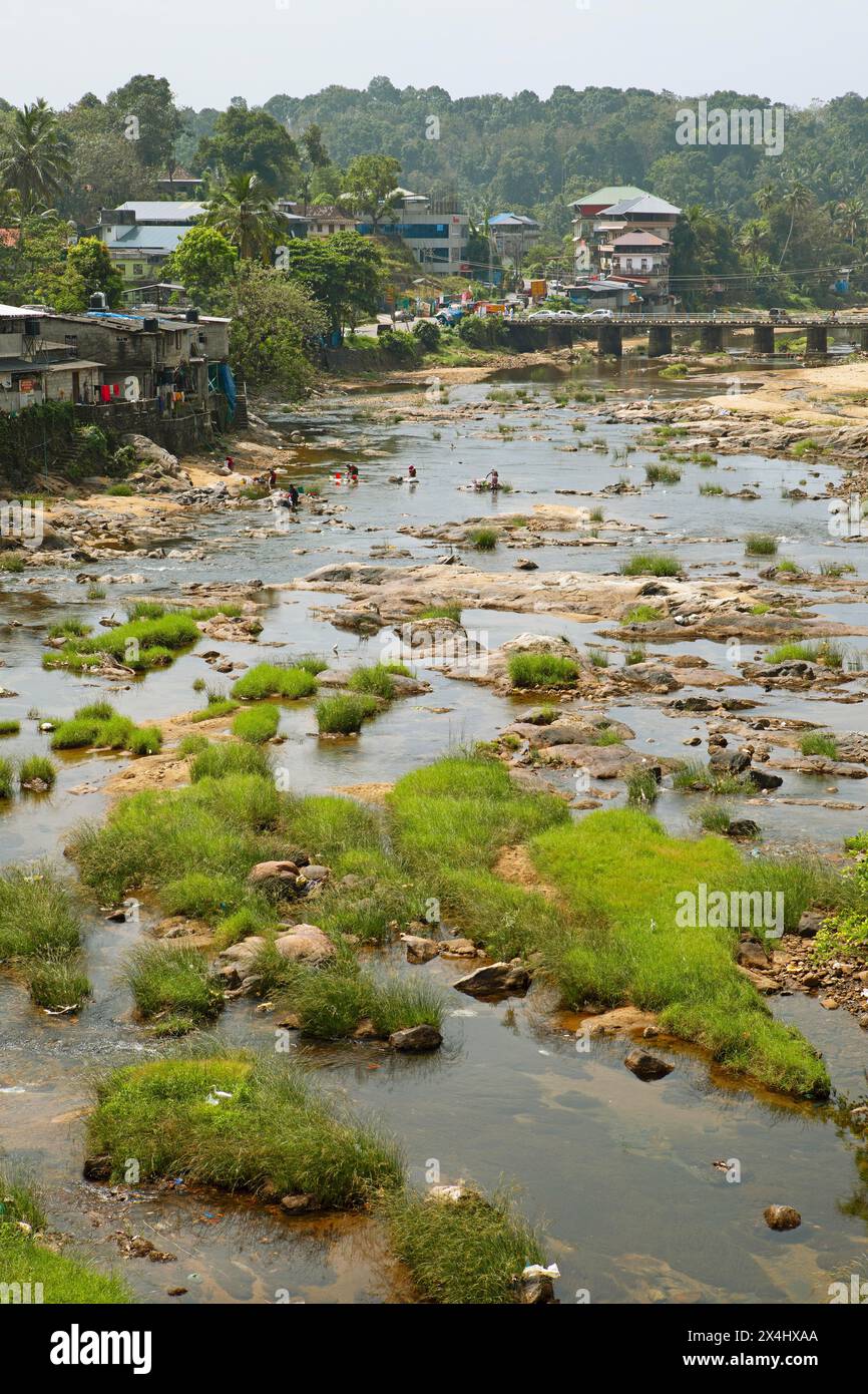 Indian people washing clothes in the Periyar River, Mundakayam, Kerala ...