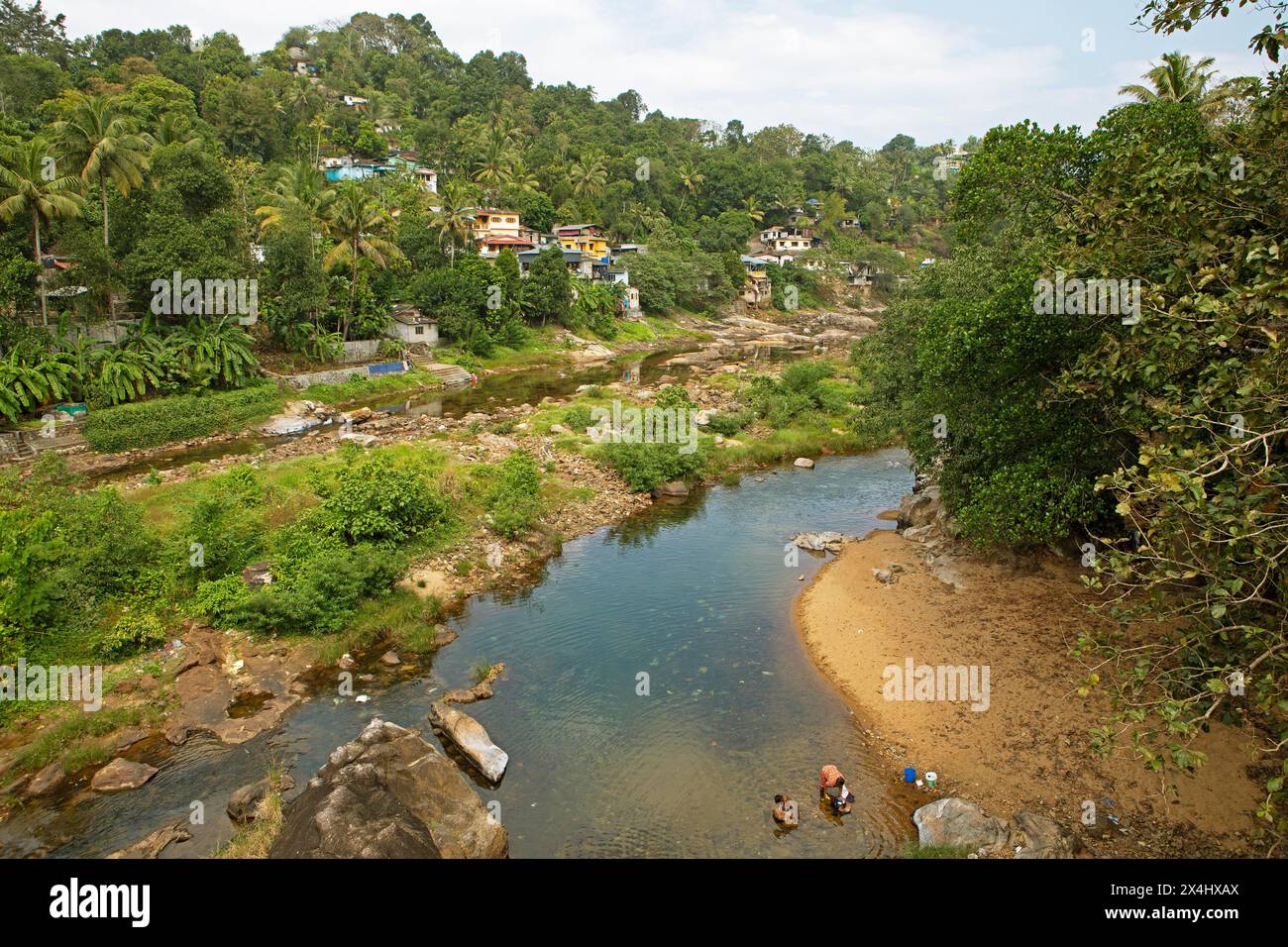 Indian people washing clothes in the Periyar River, Mundakayam, Kerala ...