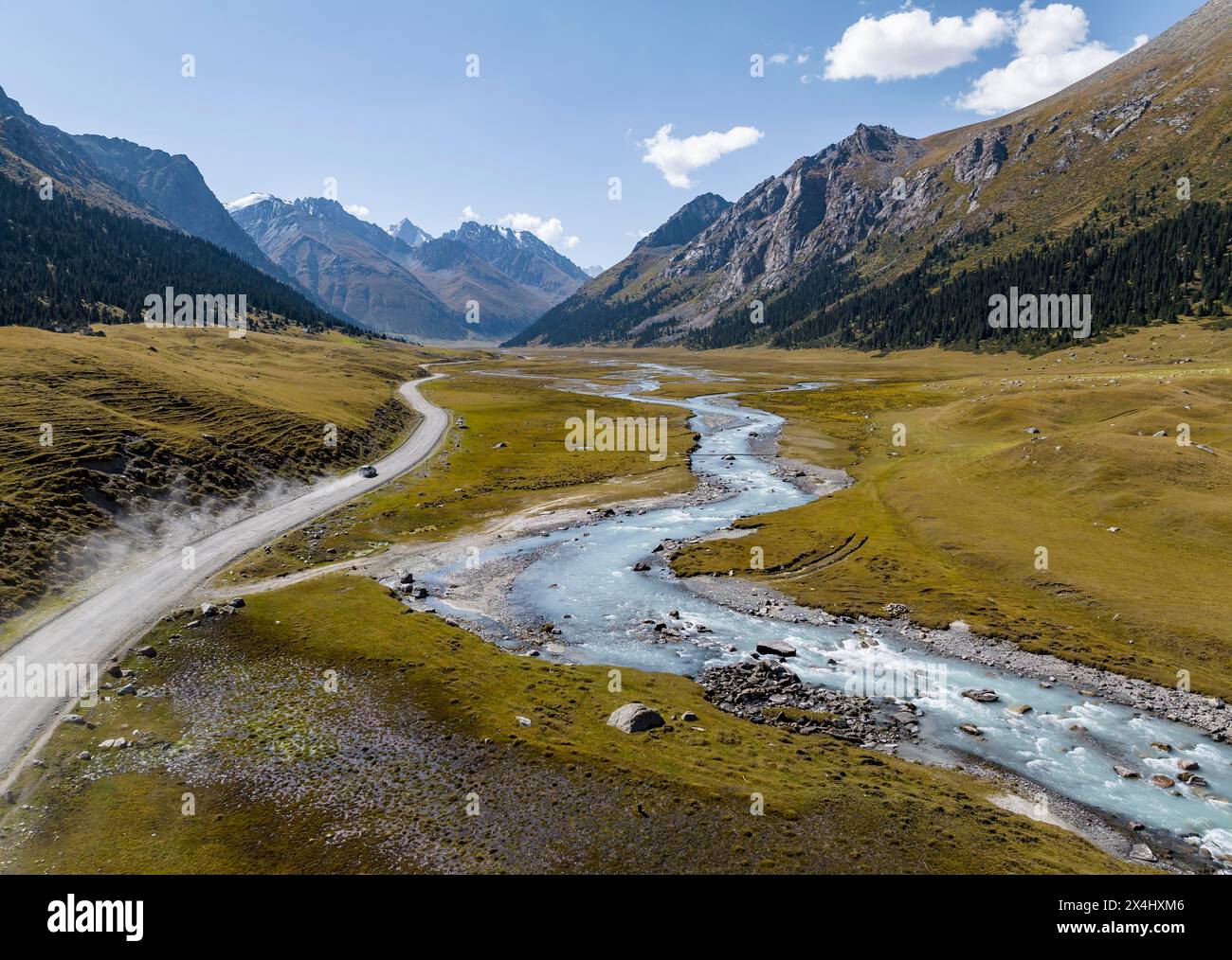 Car on road, mountain river in green mountain valley in the Tien Shan ...