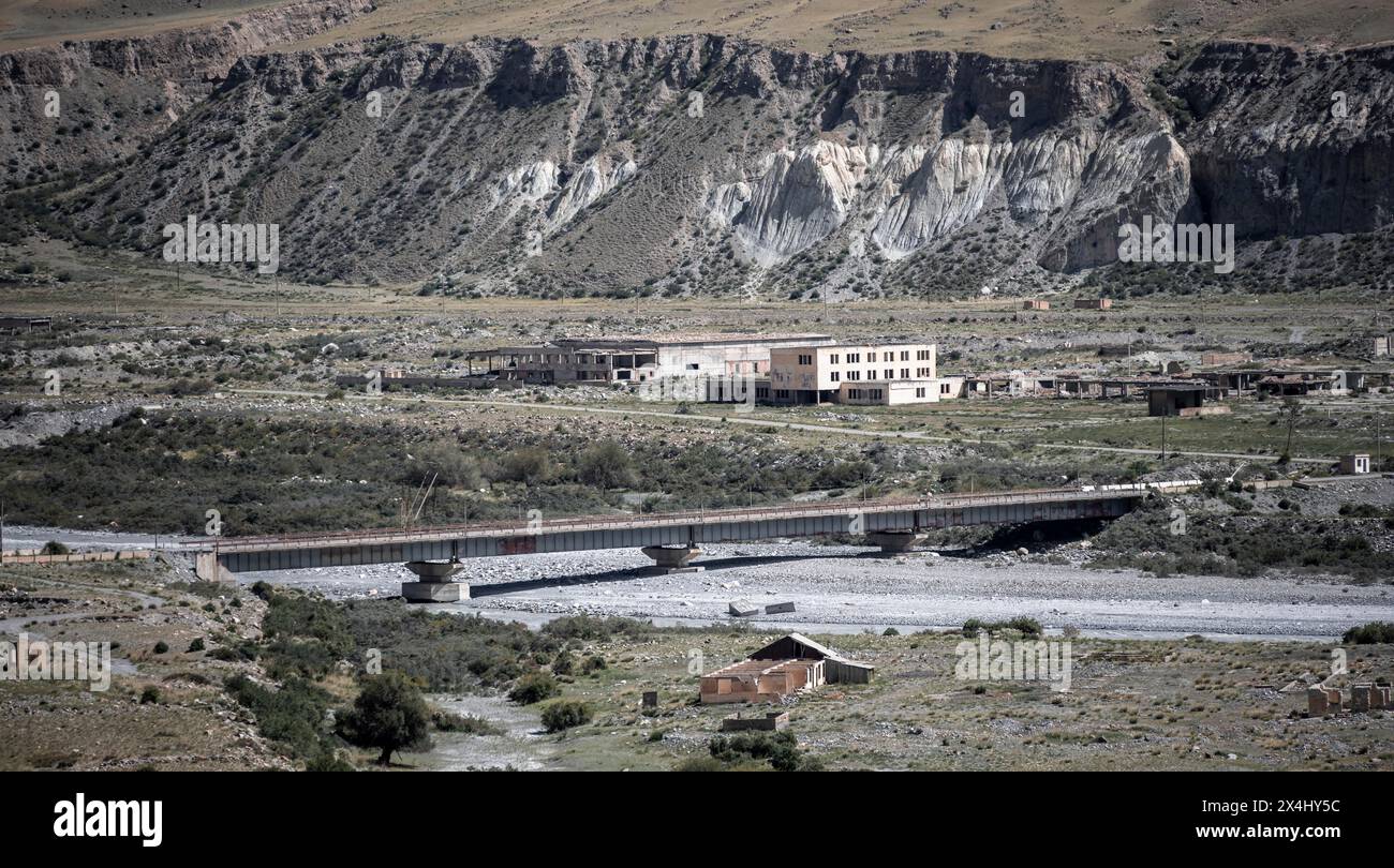 Abandoned buildings in a barren landscape, ghost town of Enilchek in ...
