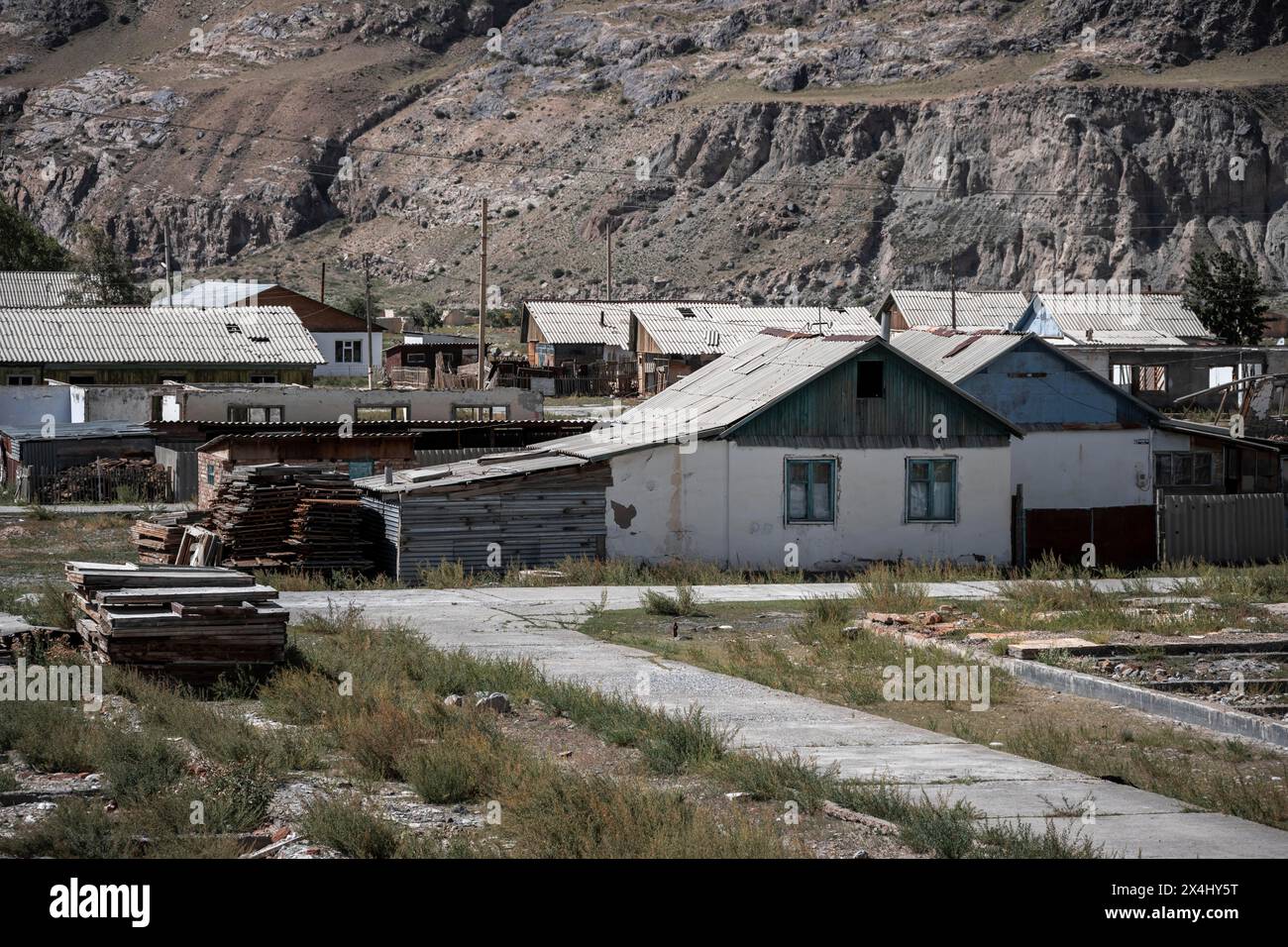 Abandoned buildings in a barren landscape, ghost town of Enilchek in ...