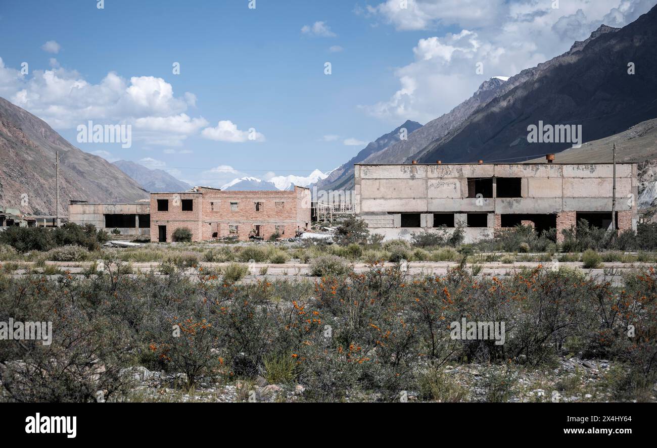 Abandoned buildings in a barren landscape, ghost town of Enilchek in ...