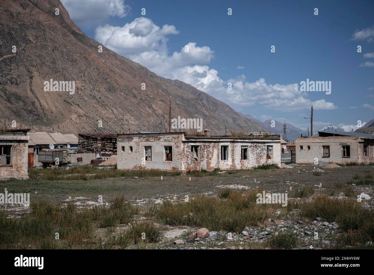 Abandoned buildings in a barren landscape, ghost town of Enilchek in ...