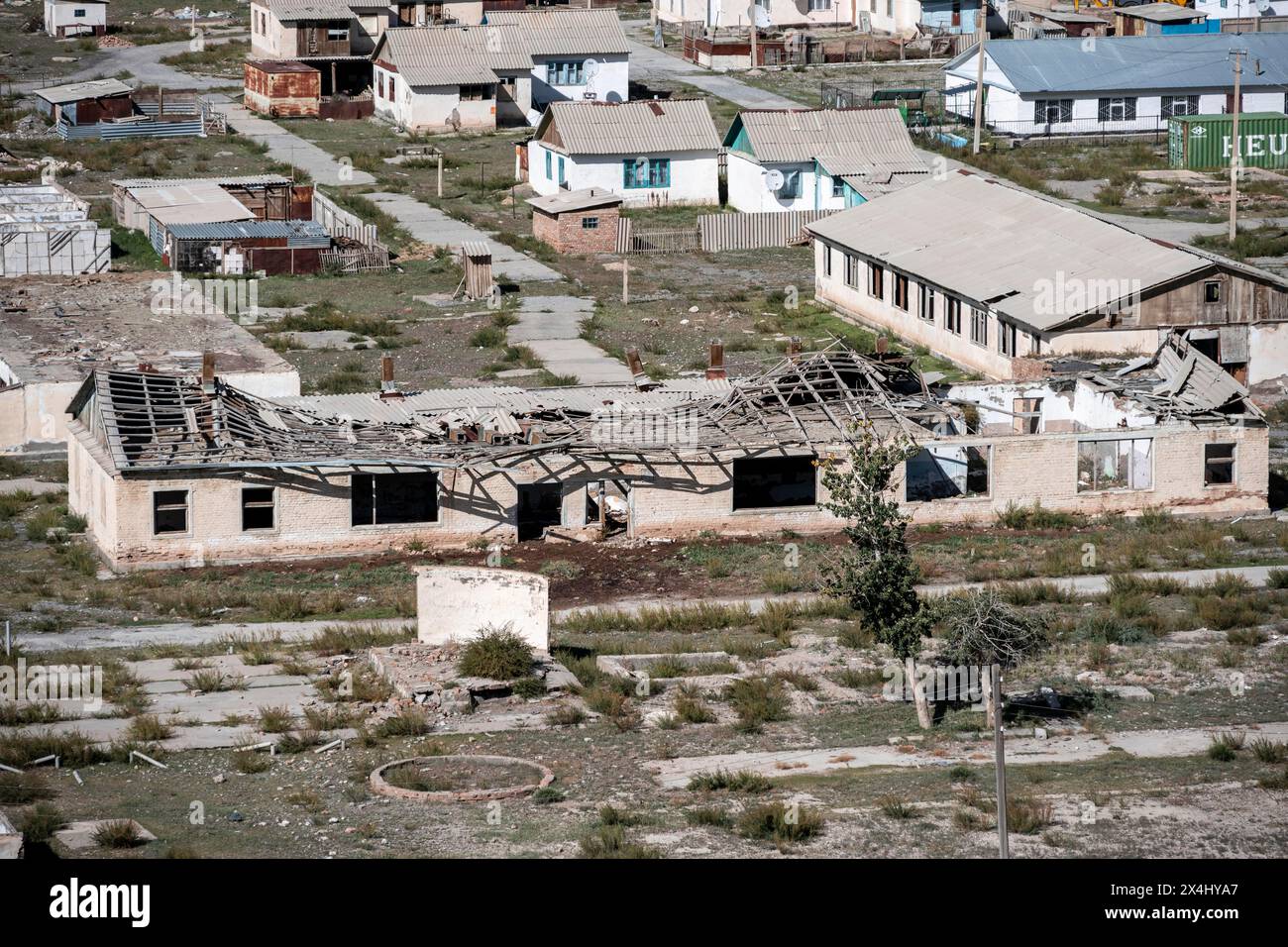 Abandoned buildings in a barren landscape, ghost town of Enilchek in ...