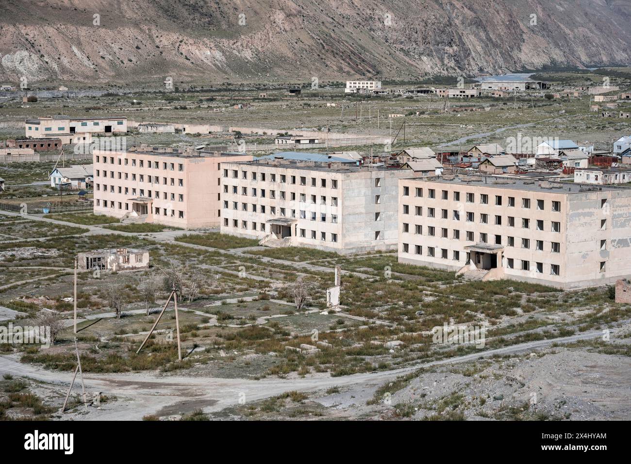 Abandoned buildings in a barren landscape, ghost town of Enilchek in ...