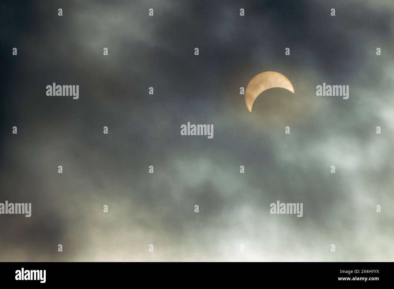 early stage of total Solar Eclipse seen through the clouds Hamilton ...