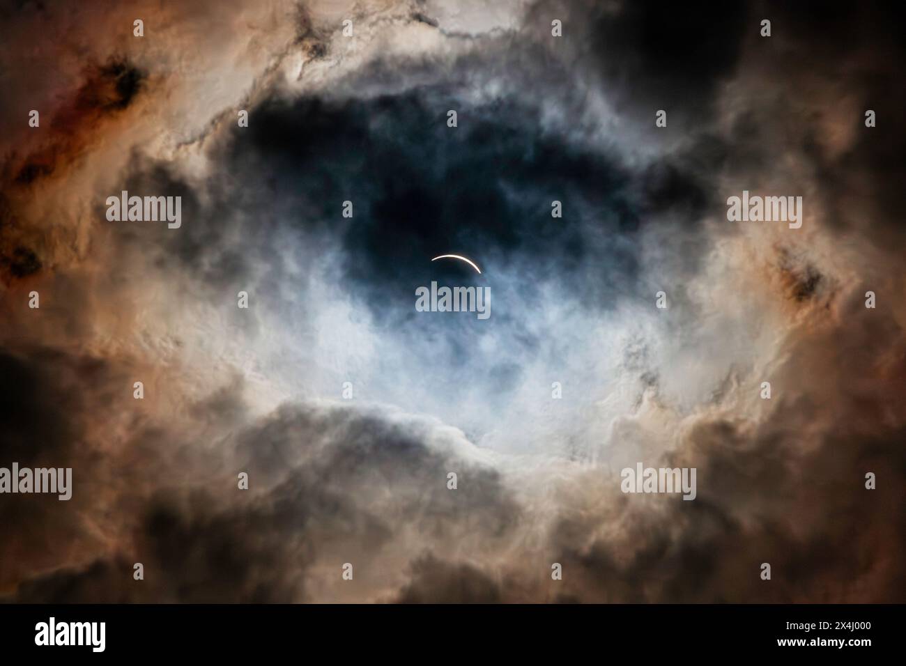 seconds before total Solar Eclipse seen through the clouds Hamilton, Ontario, Canada, April 8th ...