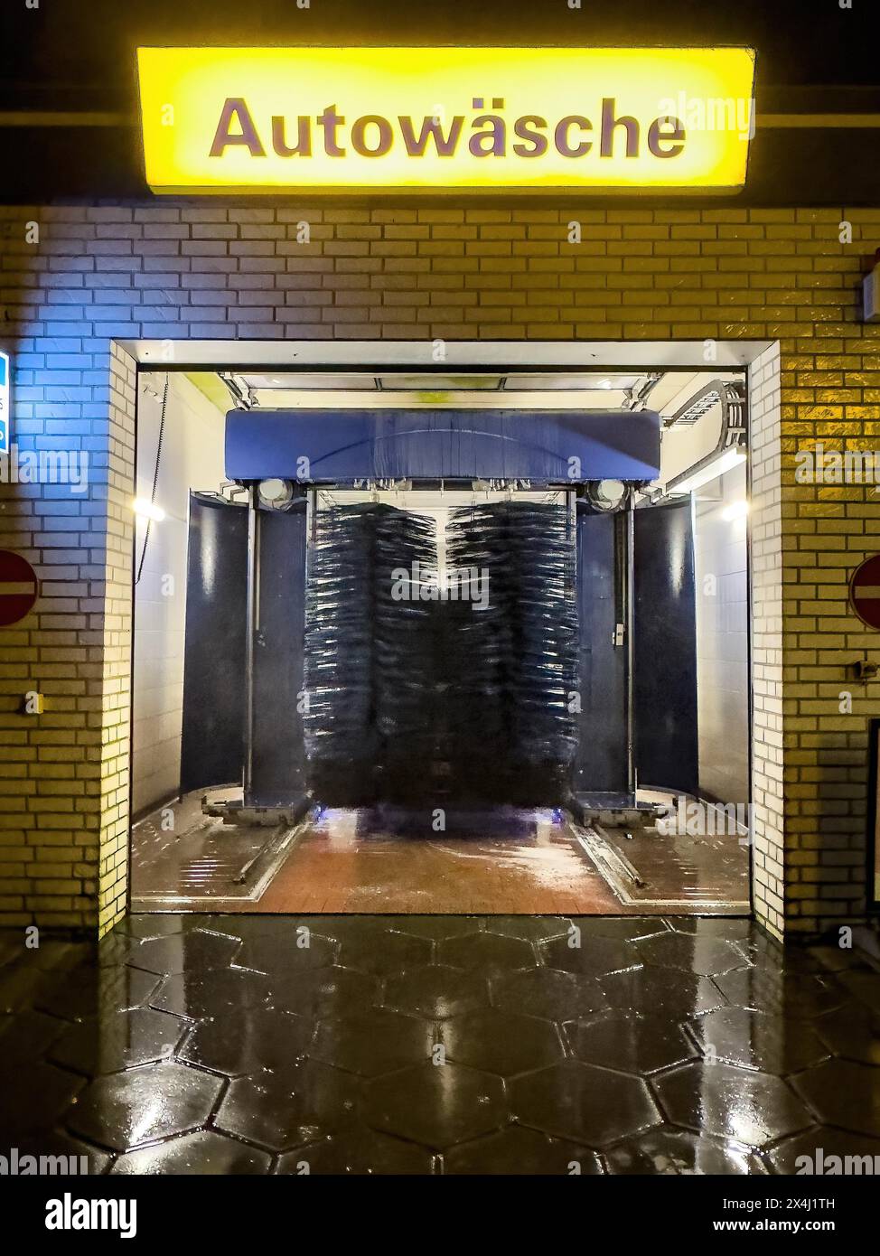 View of car wash at night with rotating brushes textile brushes for ...