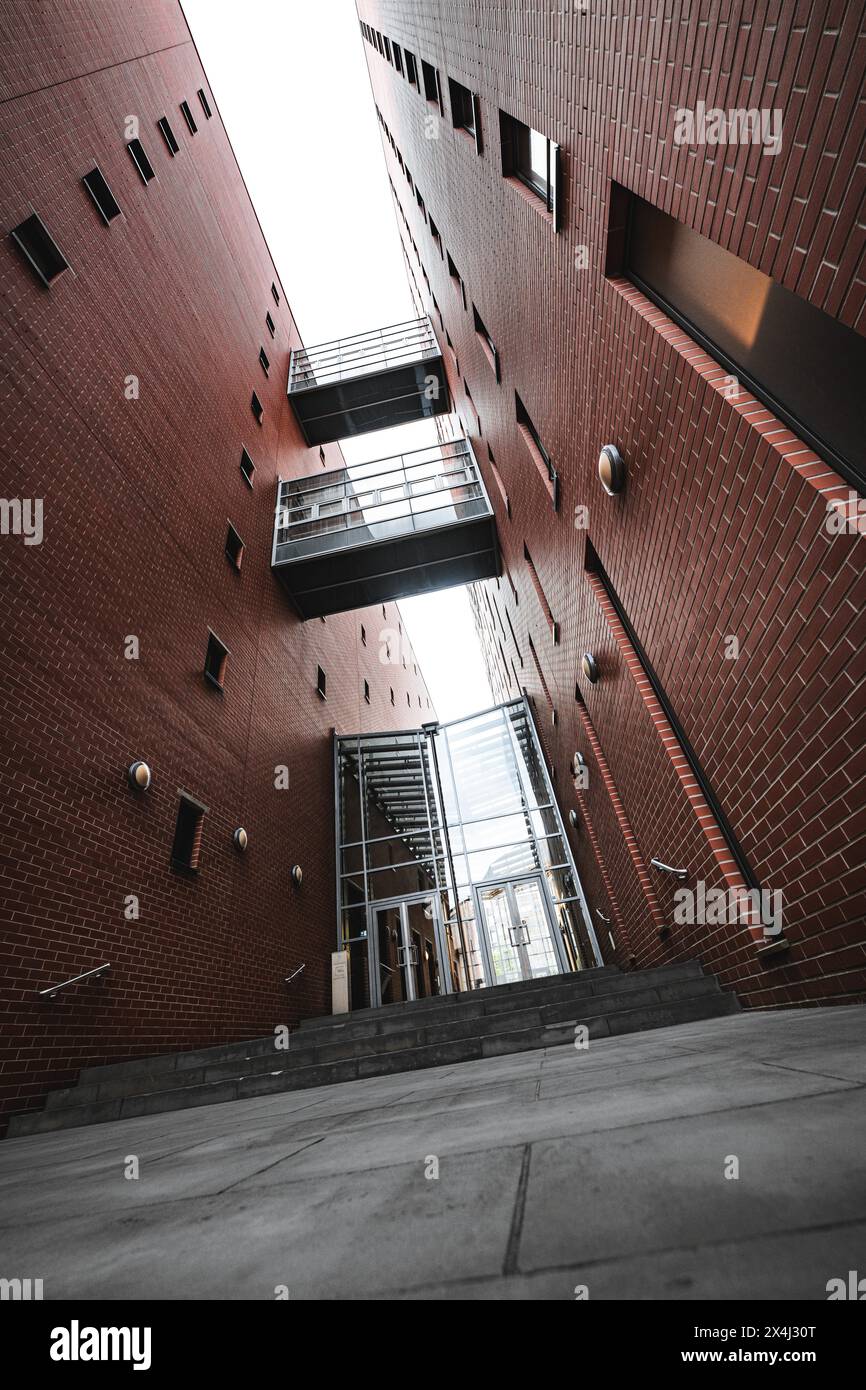 View through a modern brick corridor with windows and passageway ...