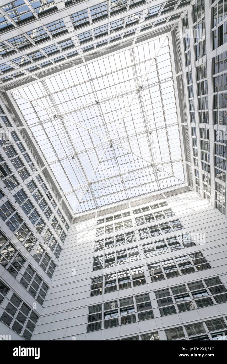 View upwards through a glass roof to the clear sky with geometric ...