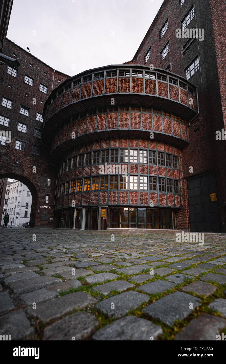 Round historic brick building with arched windows under a cloudy sky ...