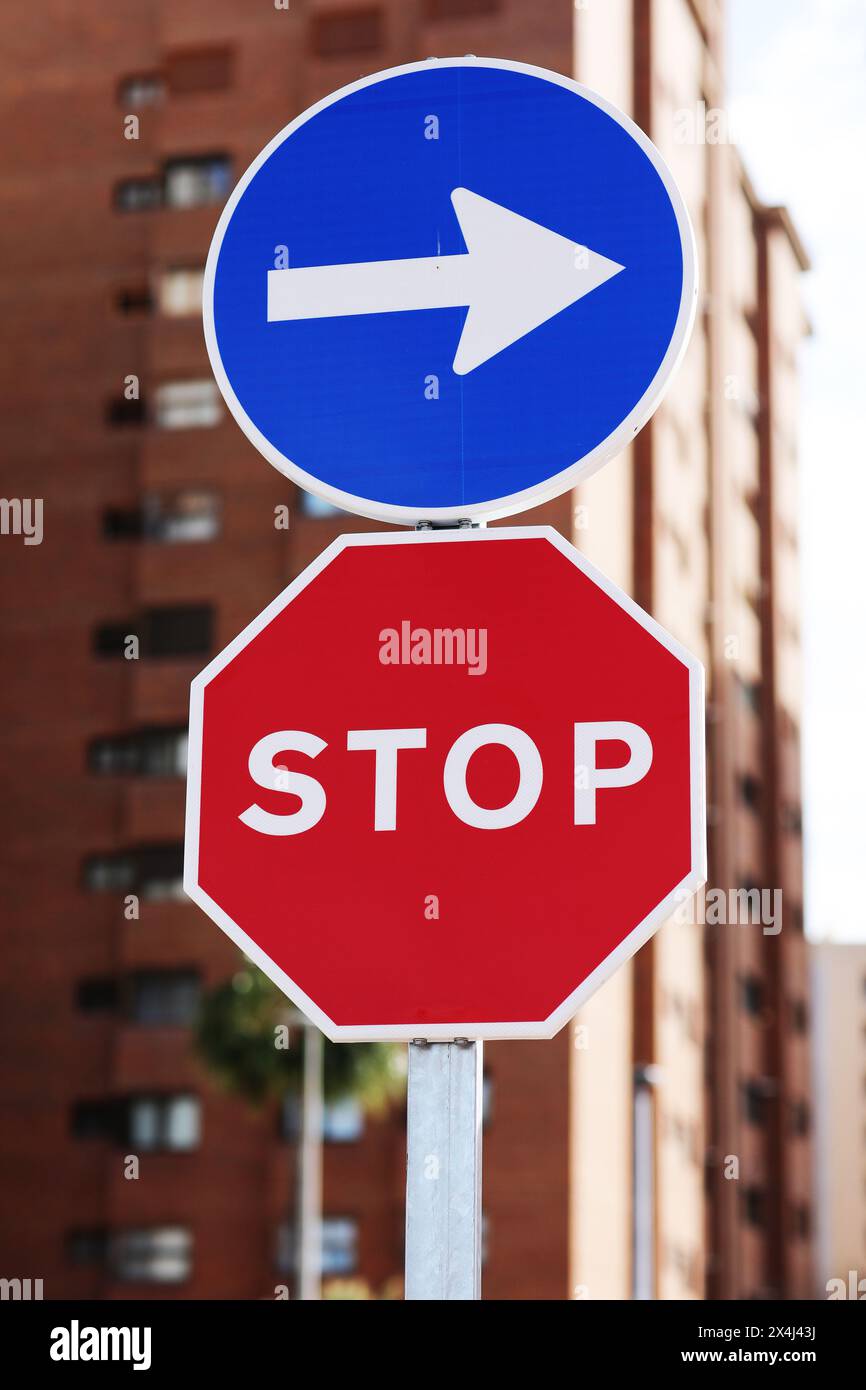 Traffic rules. Red road sign stop and blue and white right directional ...
