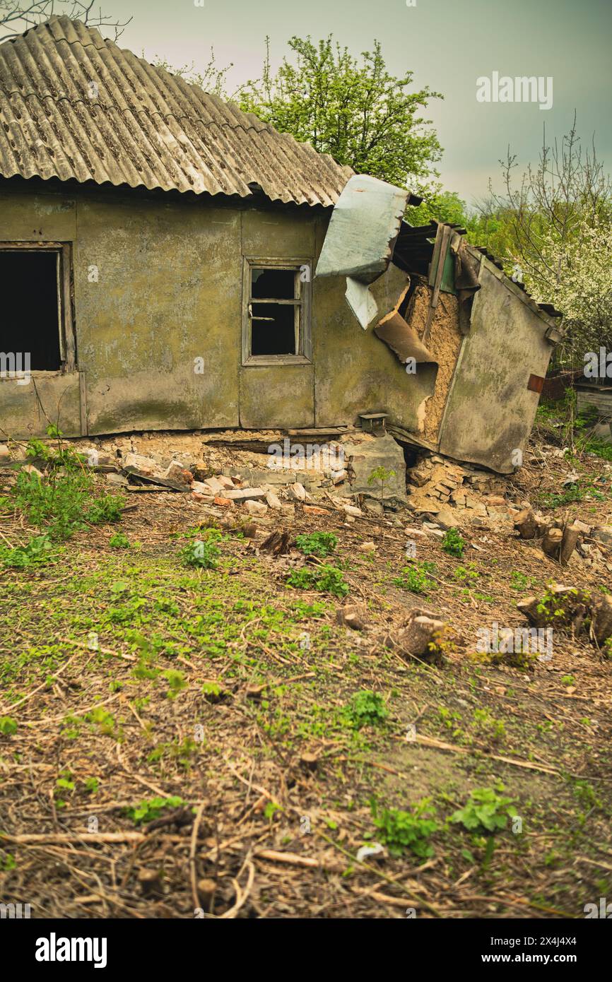 Dilapidated Rural Cottage on a Cloudy Day With Overgrown Vegetation. Abandoned house falling ...