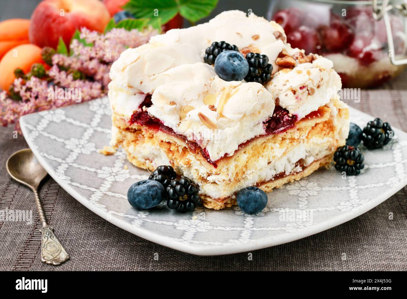 Layer fruit cake with meringue topping. Party dessert Stock Photo - Alamy