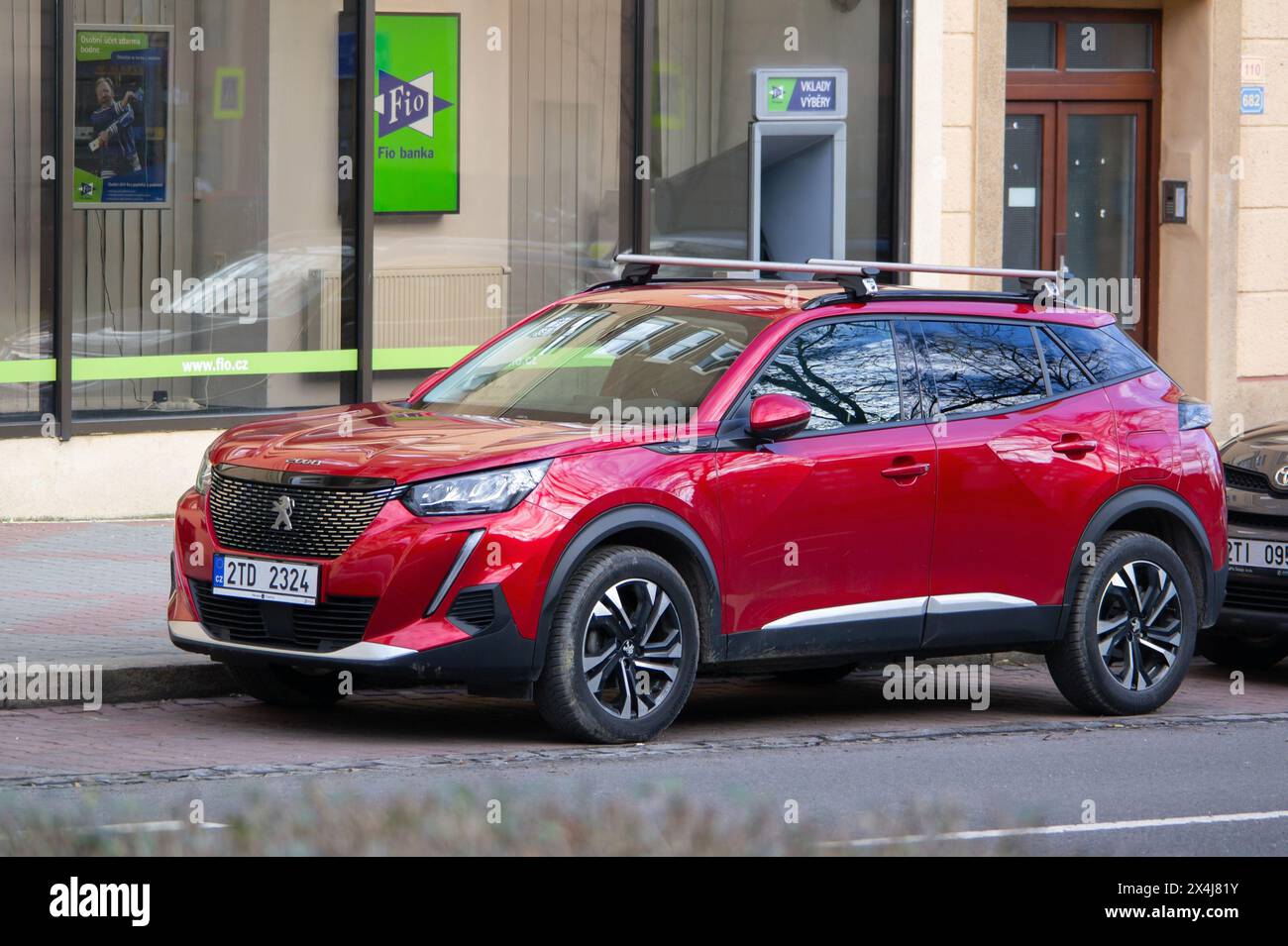 OSTRAVA, CZECH REPUBLIC - DECEMBER 19, 2023: Bright red Peugeot 2008 ...