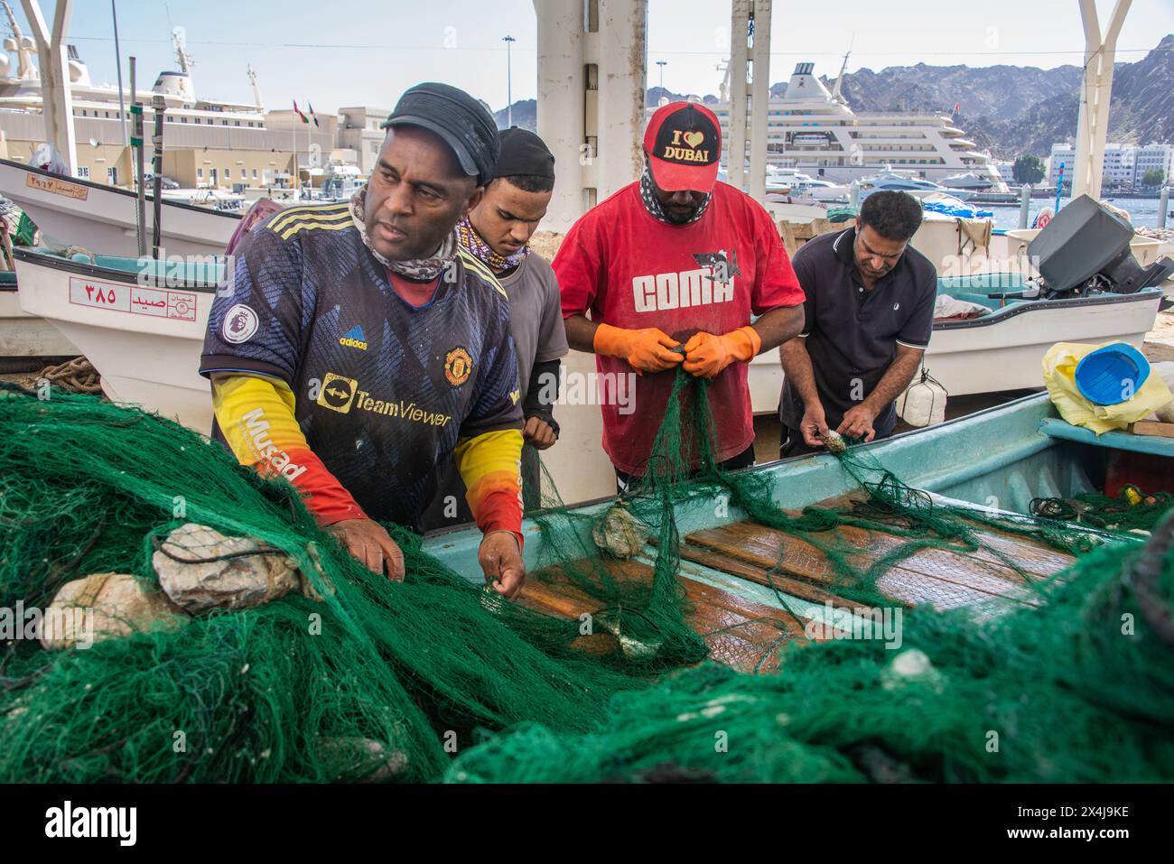 Cleaning fishing nets at the Fish Market, Mutrah Souq, Muscat, Oman ...