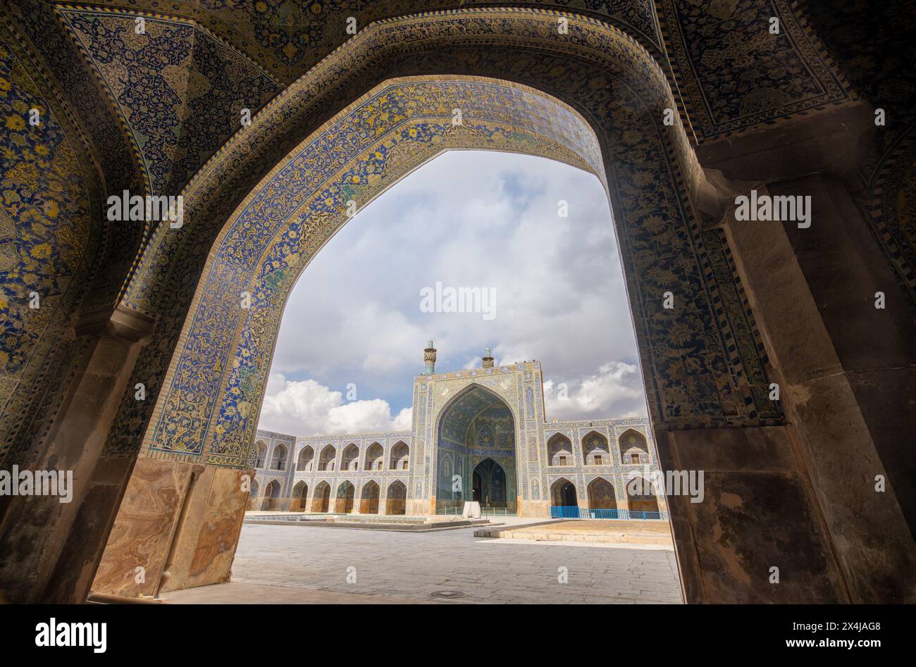 Stunning Persian-Islamic architecture with minarets and intricate tiles in vibrant blue tones ...