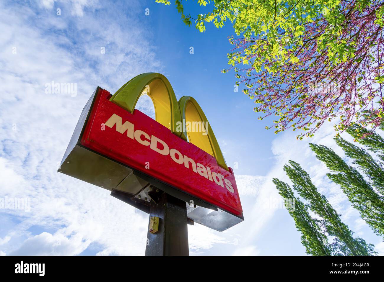 Sign and logo of a McDonald's restaurant. McDonald's Corporation is an ...
