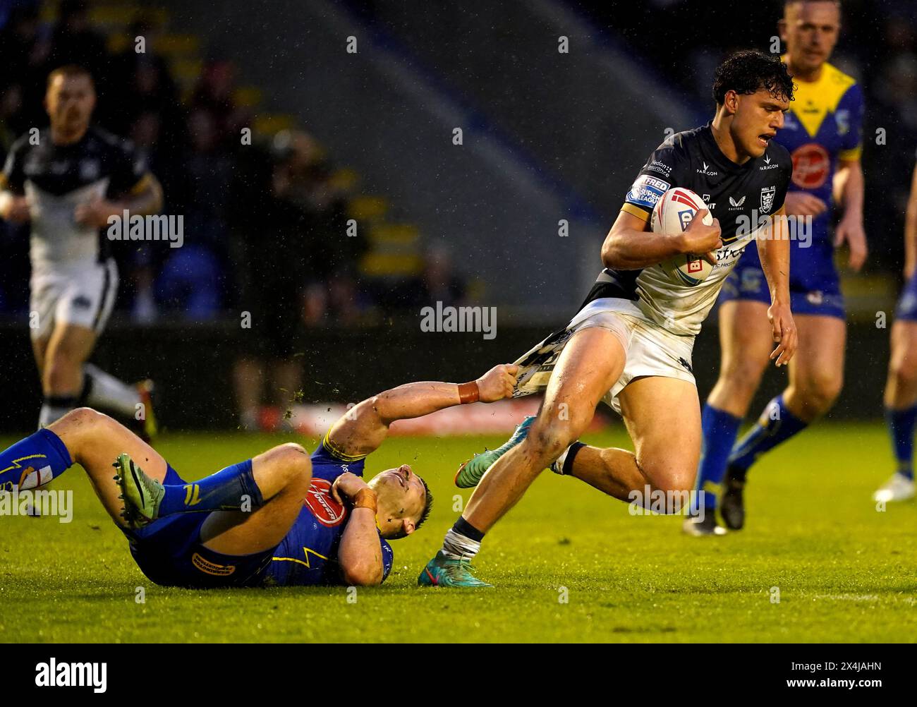 Hull FC's Lewis Martin gets away from Warrington Wolves' George ...