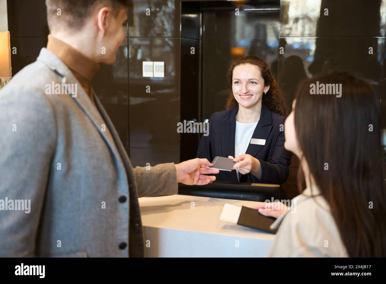 Tourist couple checking into hotel upon arrival Stock Photo - Alamy