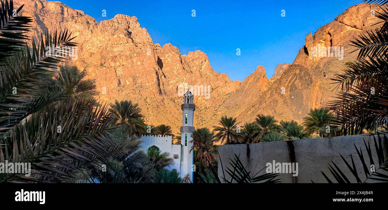 The Western Hajar mountains rise above the mosque in Bald Sayt (Balad ...