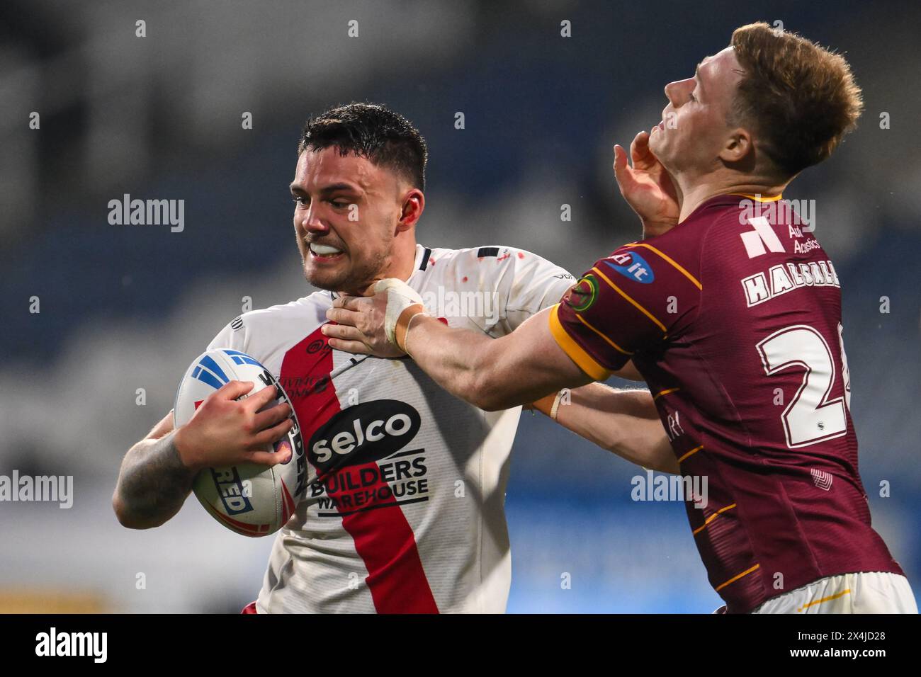 Oli Partington of Salford Red Devils fends off Sam Halsall of ...