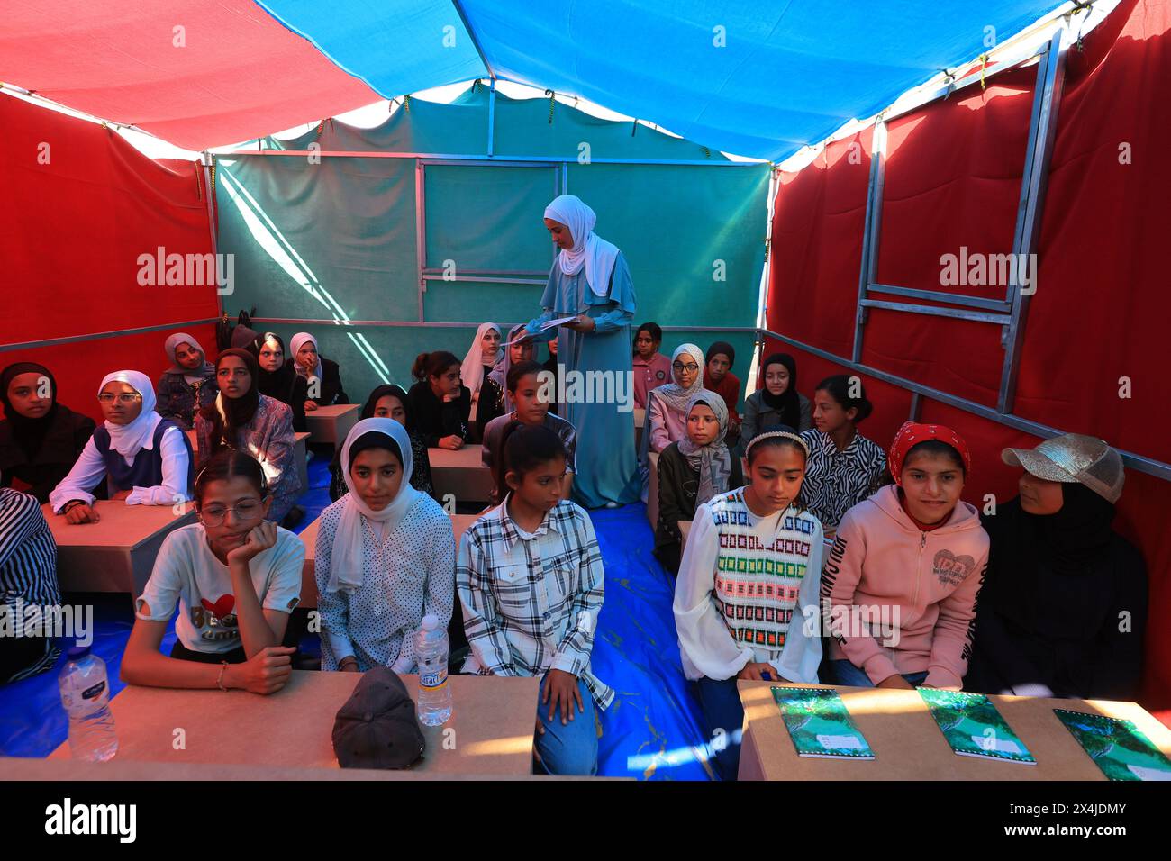 Gaza. 30th Apr, 2024. Palestinian students attend a class at a tent ...