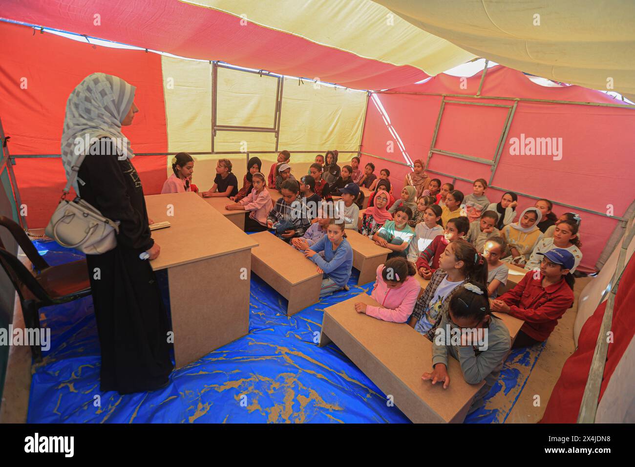 Gaza. 30th Apr, 2024. Palestinian students attend a class at a tent ...