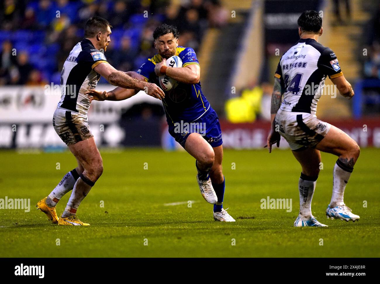 Warrington Wolves' Toby King is tackled by Hull FC's Ed Chamberlain ...