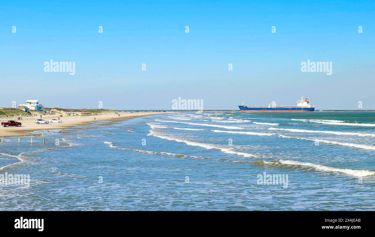 Afternoon beach scene at the Gulf of Mexico with sand, waves, cars ...