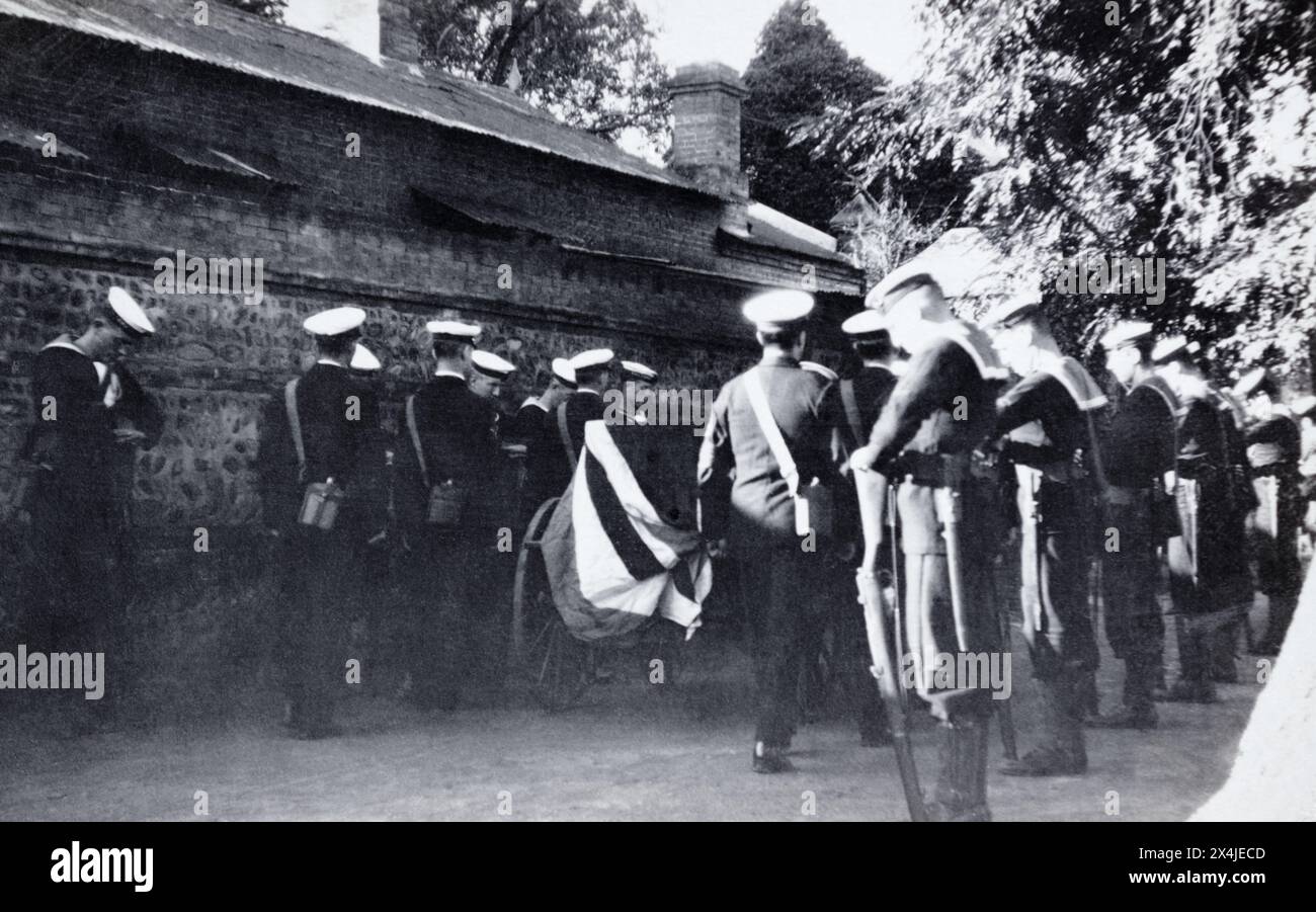 A funeral carriage passing a Royal Navy guard of honour with reversed ...