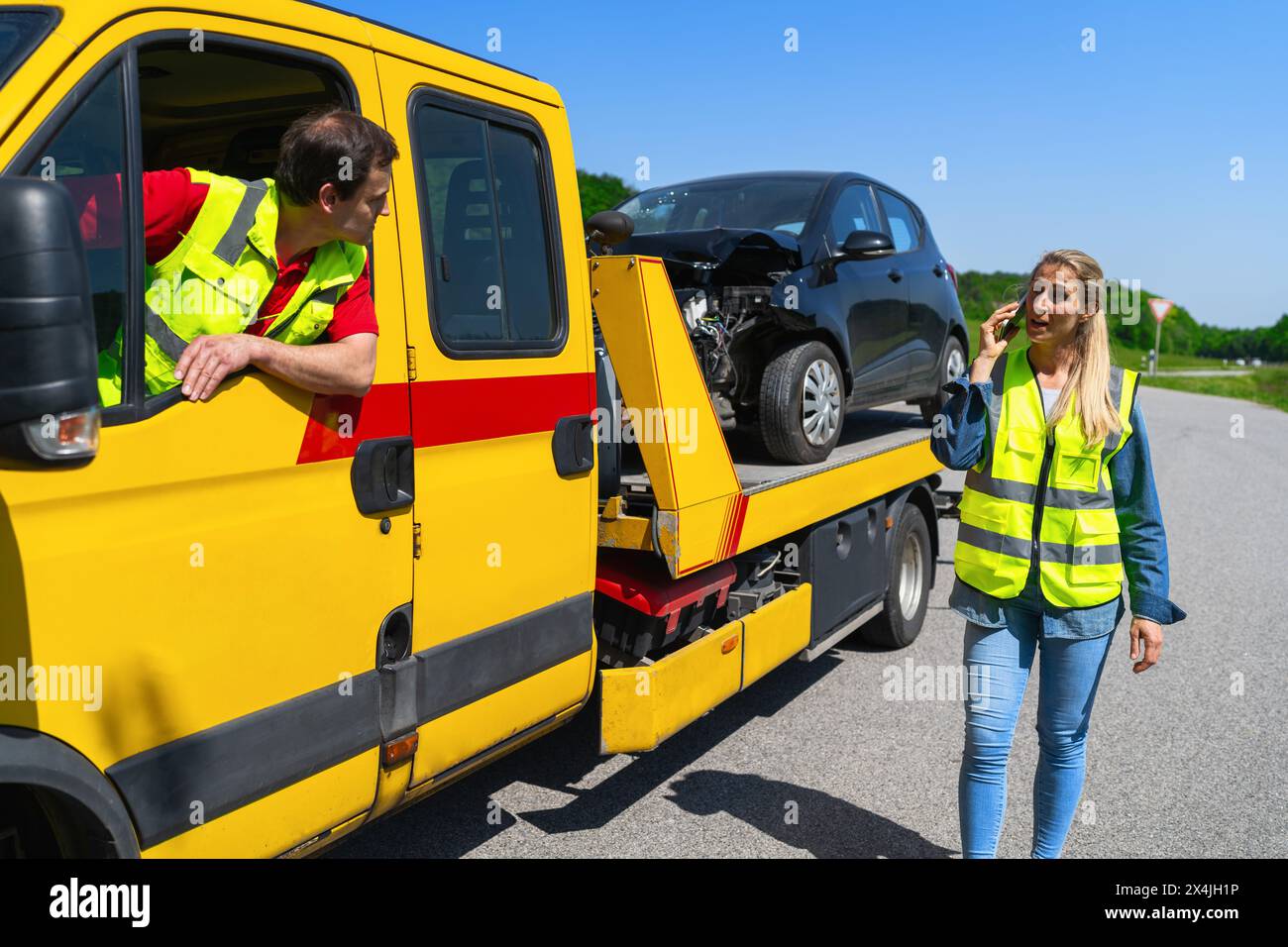towing service prepares to leave for the workshop while the driver of ...
