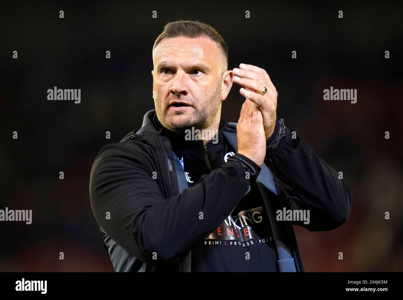 Bolton Wanderers manager Ian Evatt applauds the fans following the Sky ...
