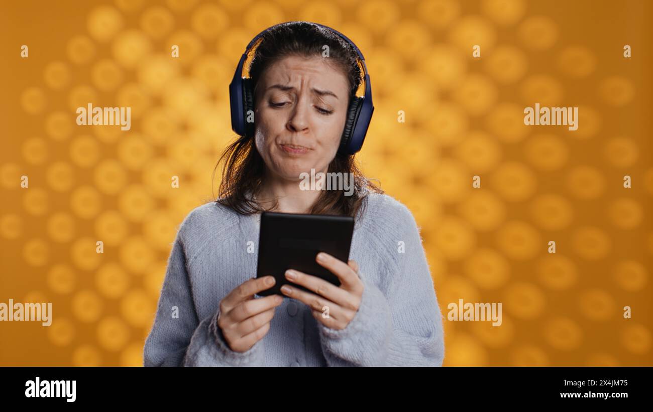 Voice actor frowns while reading ebook, portraying character, studio ...