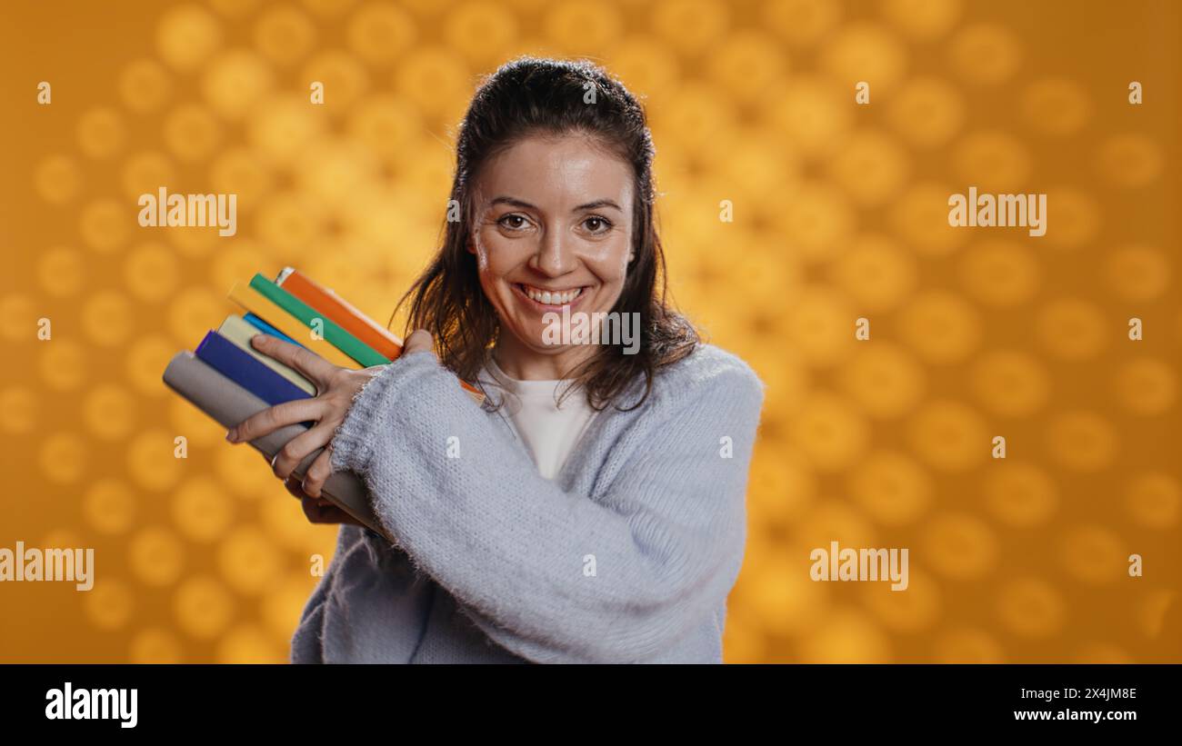 Excited woman delighted about books ordered, treasuring them, isolated ...