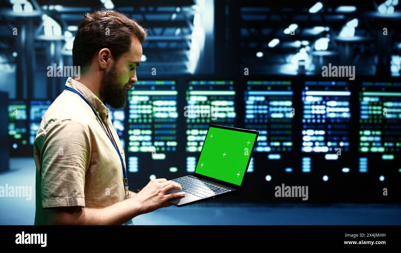 Expert using chroma key laptop to check server hub configuration settings, close up. Mechanic ...