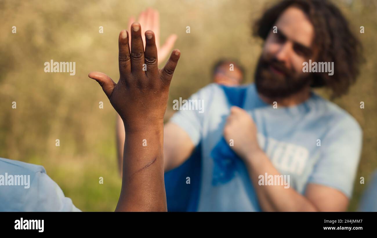 Team leader sharing a high five with her volunteers members after ...