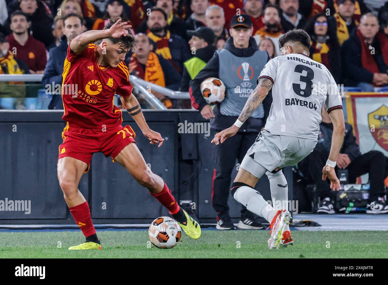 Paulo Dybala, left, of Roma, is challenged by Piero Hincapie', of Bayer ...