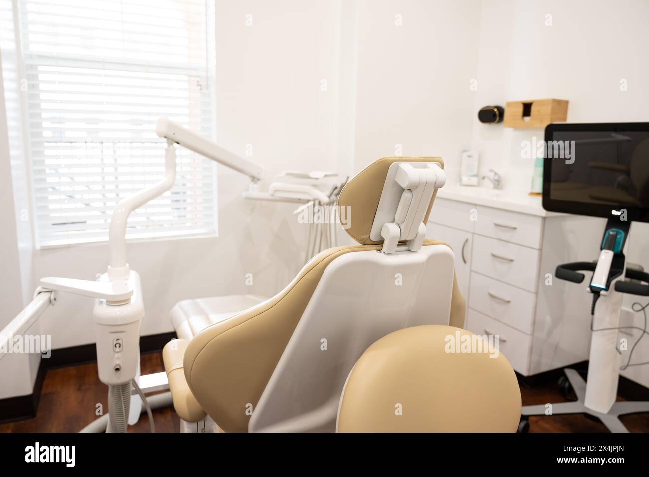 Dentist office treatment room has comfortable adjustable chair for ...