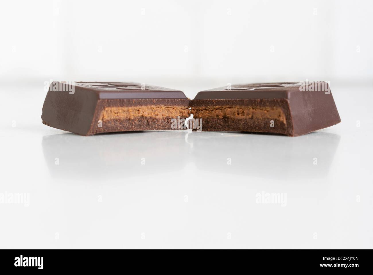 dark chocolate with hazelnut butter filling on white background, shown ...